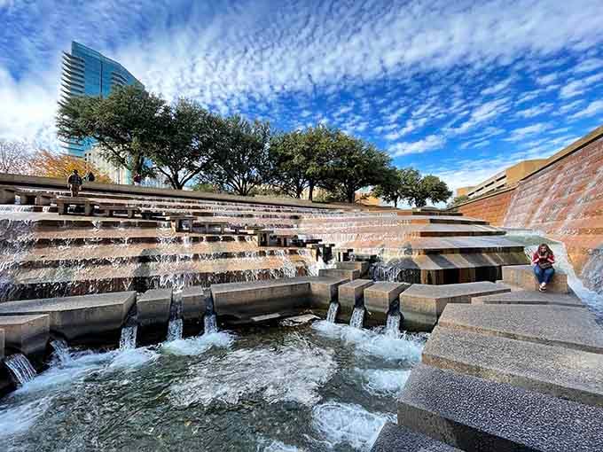Cascading water tumbles down concrete steps at Fort Worth Water Gardens, proving downtown stress doesn't stand a chance here.