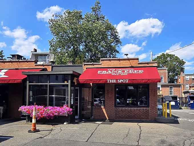 That bold red awning and cheerful flower box say one thing clearly: legendary pizza lives here.