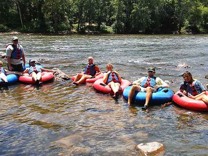 Floating together like a colorful parade of inner tubes, families drift downstream in perfect summer harmony.