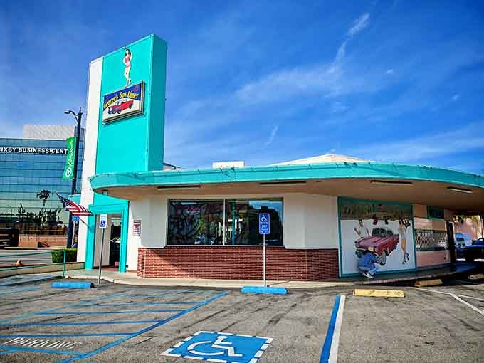 That bold turquoise tower rising against a California blue sky is basically a neon invitation to happiness.