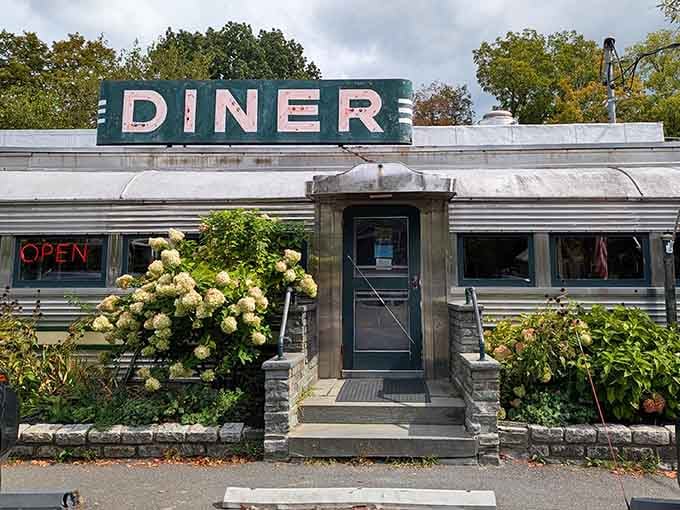 That glowing "OPEN" sign and blooming hydrangeas are basically nature's way of saying breakfast is ready.