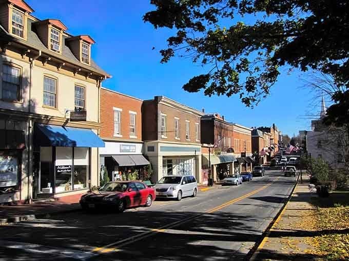 Lexington's Main Street glows under autumn sun, where brick storefronts and blue awnings invite a slow, satisfying stroll.