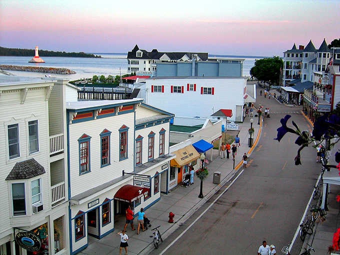 A pink sunset melts over Mackinac Island's Main Street, where no car has ever dared to interrupt the magic.