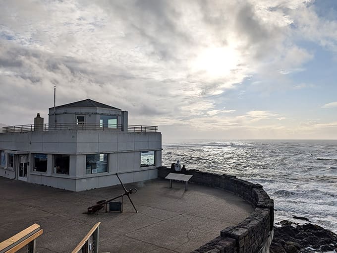 Storm clouds gather above the observation deck, creating that moody coastal atmosphere perfect for dramatic whale sightings.