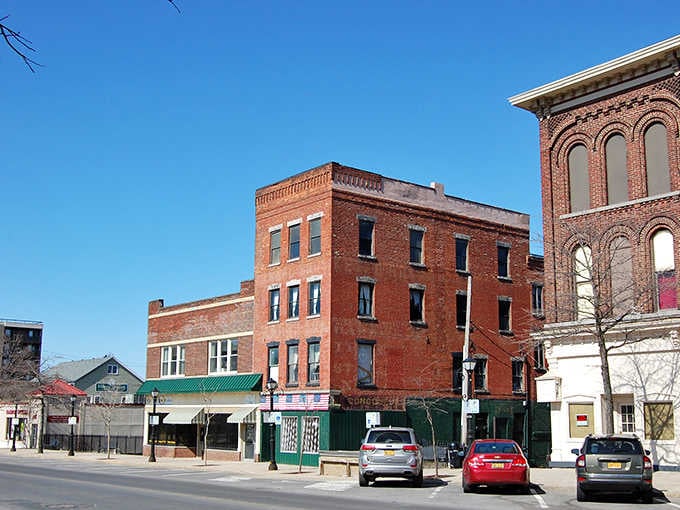 Oswego's sturdy brick streetscape stands tall under a brilliant blue sky, quietly daring you to explore.