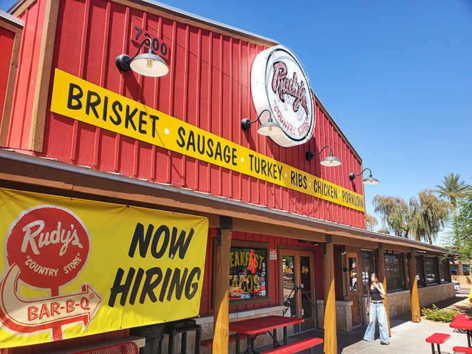 That bright red barn facade practically shouts "serious BBQ ahead" while the yellow banner promises all your smoked meat dreams.