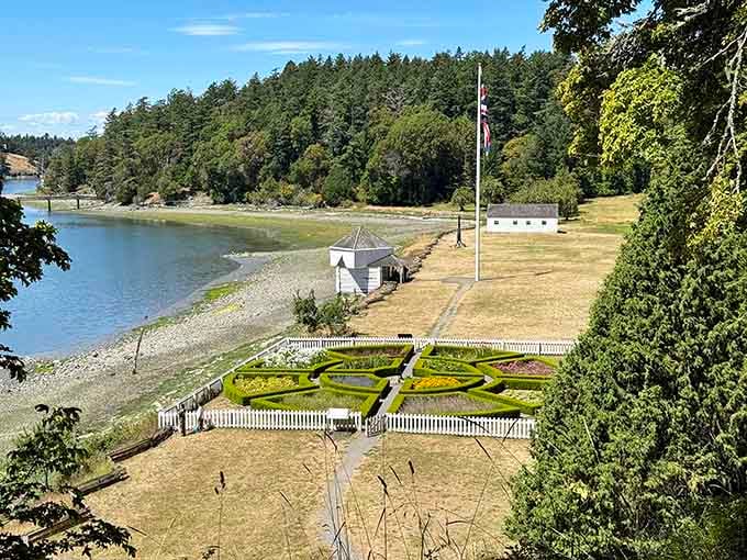 A manicured formal garden meets the sparkling shoreline at San Juan Island's English Camp, where history feels surprisingly well-dressed.