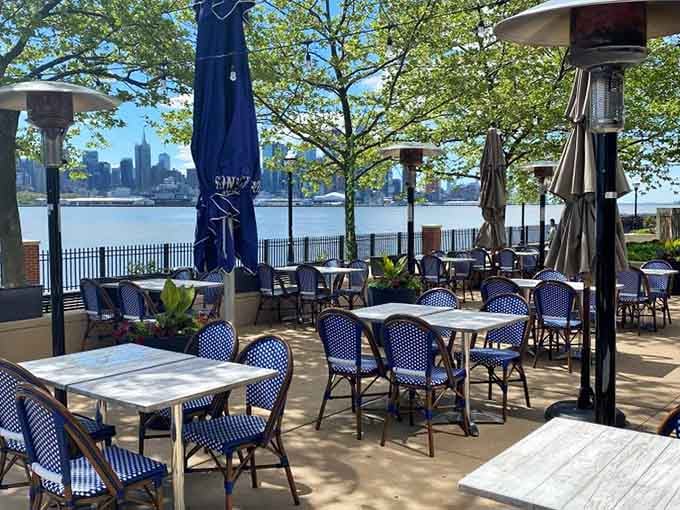 Blue bistro chairs, dappled sunlight, and Manhattan glittering across the Hudson. Someone pinch me.