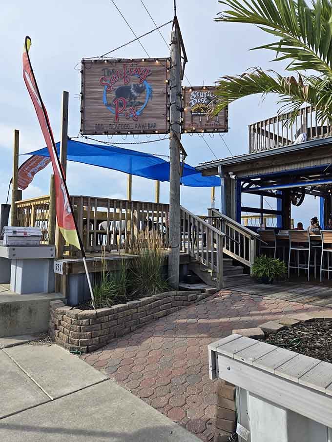 That rustic wooden sign strung with warm lights says it all: something delicious is waiting just up those steps.