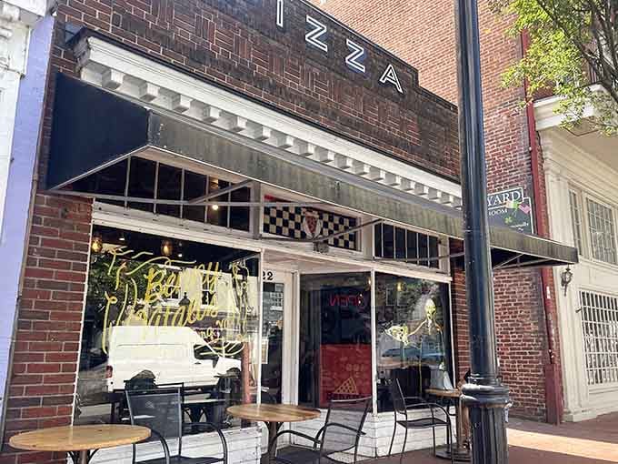 The brick facade and checkered awning signal you've arrived at pizza paradise in downtown Fredericksburg.