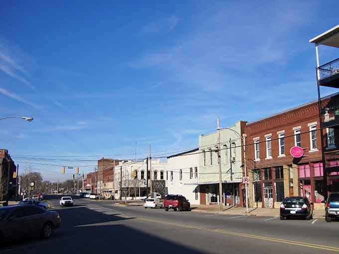 Tuscumbia's downtown brick storefronts stretch under a brilliant blue sky, quietly saying, "We've got history and we're keeping it."