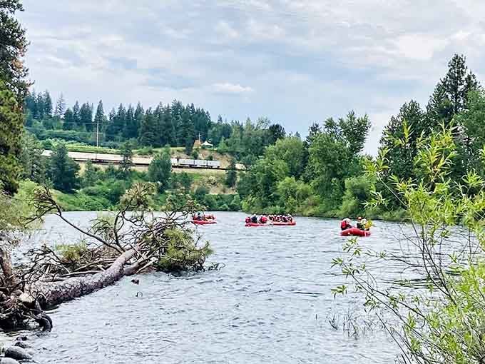 Red tubes dotting the Wenatchee River like floating cherries against a backdrop of evergreen forests and summer skies.