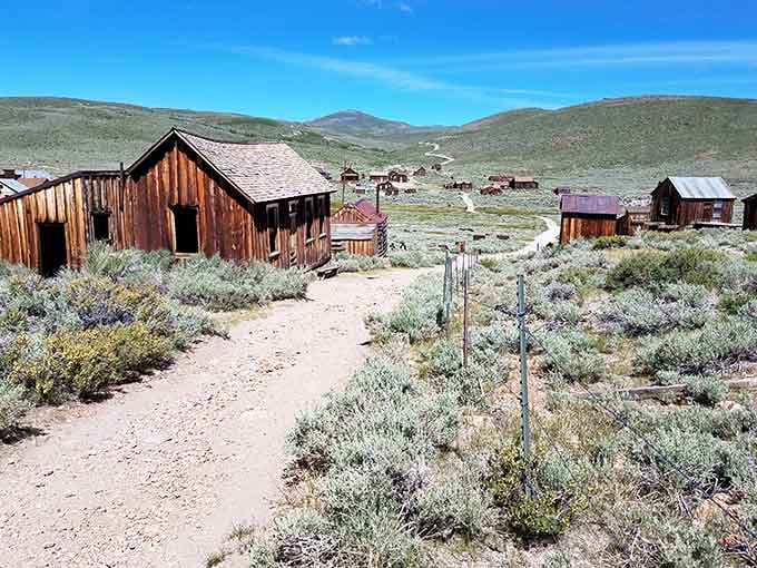 That winding dirt path leads through a ghost town so perfectly frozen in time it's almost eerie.