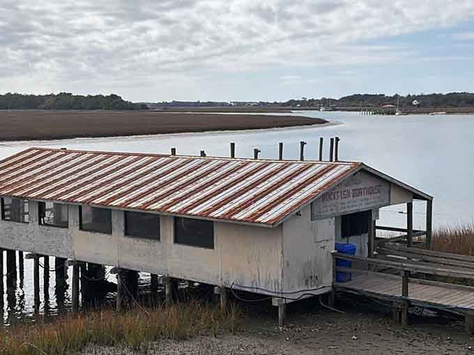 Perched on stilts over the marsh, this rusty-roofed gem proves that beauty comes in wonderfully weathered packages.