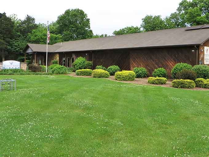 Spring wildflowers dot the lawn at Forest Edge, where the perfectly rounded shrubs look like nature's own welcome committee.