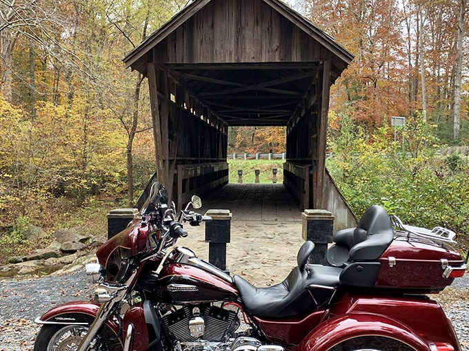 Fall foliage and a gleaming Harley-Davidson make Pisgah Bridge look like a postcard nobody sent you yet.