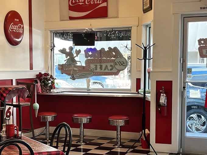 Chrome stools, Coca-Cola signs, and a checkered floor — this interior is a love letter to every great diner you've ever visited.