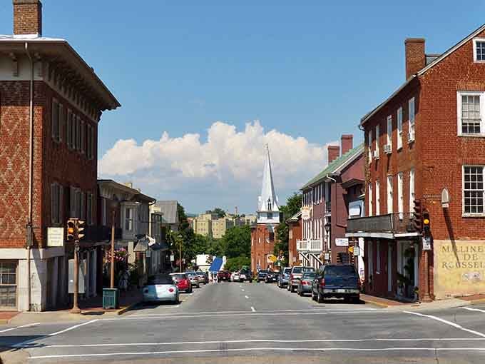 A white church steeple pierces the summer sky above Lexington, reminding you that some towns simply got everything right.