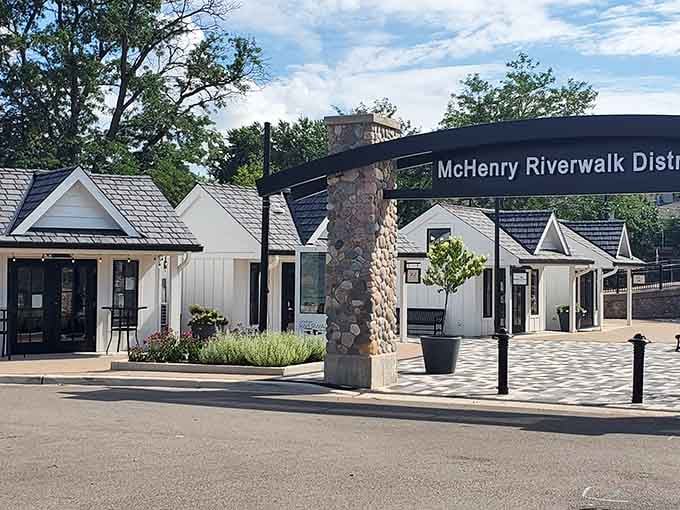 That stone column and crisp signage say it all: the McHenry Riverwalk District means business, the relaxing kind.