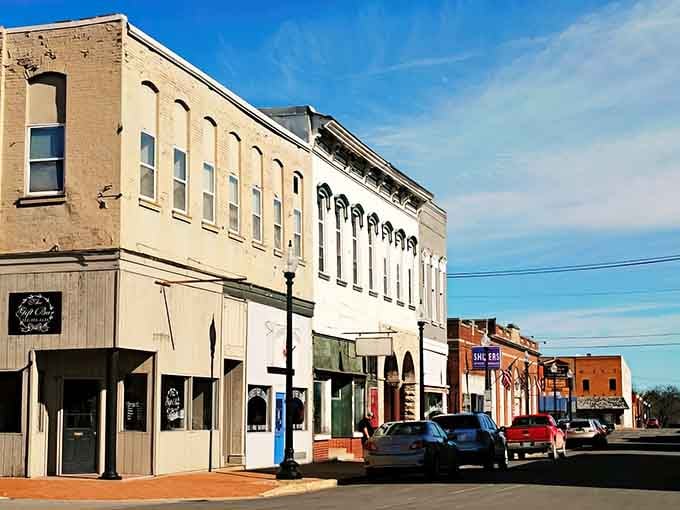 Mexico's main street stands tall under a crisp blue sky, colorful storefronts telling quiet stories of community pride.