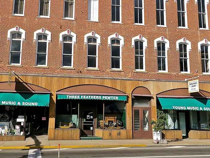 Three Feathers Pewter anchors this handsome building like a quiet promise that craftsmanship still matters around here.