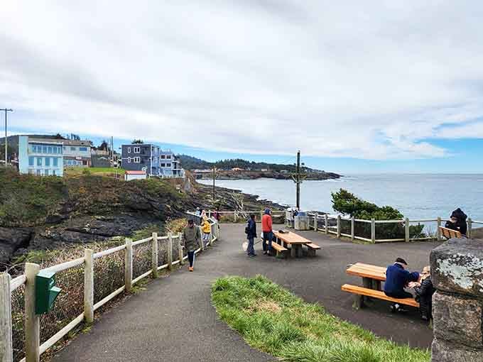 The paved walkway winds past picnic tables where visitors settle in for hours of hopeful ocean watching.