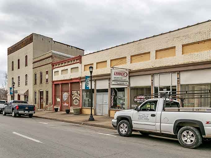 Getting some strong retro vibes here! A reliable local work truck sits parked along a quiet brick-lined downtown strip.