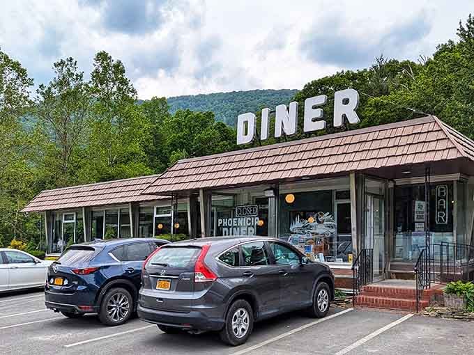 Classic roadside architecture meets culinary excellence where mountains frame every memorable meal you're about to devour.