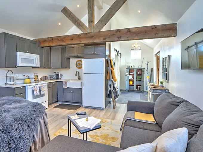 Open-concept living where rustic beams meet modern comfort, proving you can have both character and functioning appliances.