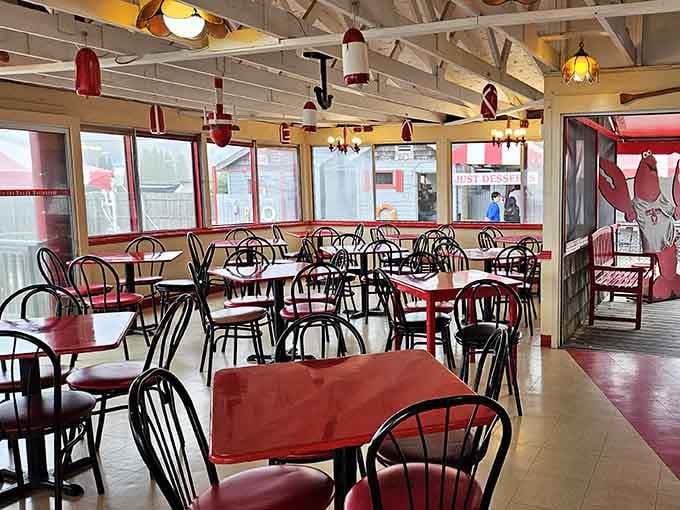 Red tables, buoys overhead, and the smell of the sea drifting in, this is what a perfect casual dining room actually looks like.