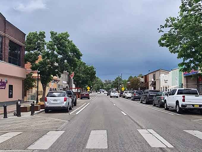 Storm clouds rolling in over downtown Alamosa only make those tree-lined sidewalks look more dramatic and inviting.