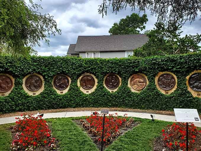 A living ivy wall dressed in bronze medallions and red blooms. Europe called, and Winter Park answered beautifully.
