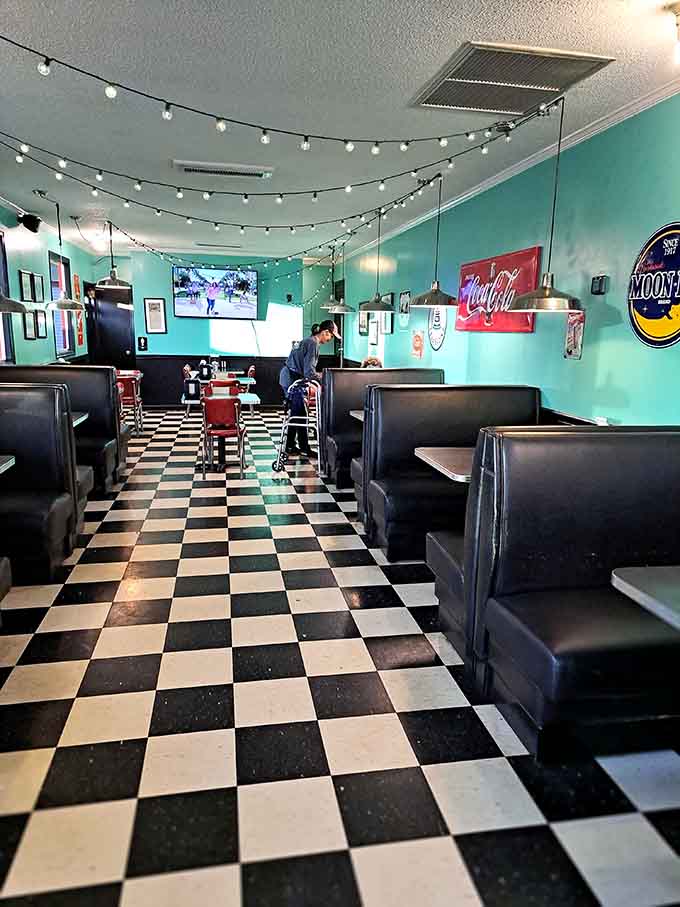 Black and white floors, teal walls, and string lights. Norman Rockwell would have eaten here every single morning.
