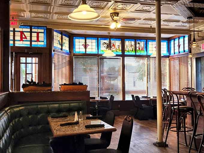 Stained glass, pressed tin ceilings, and green leather booths. This dining room means serious, beautiful business.