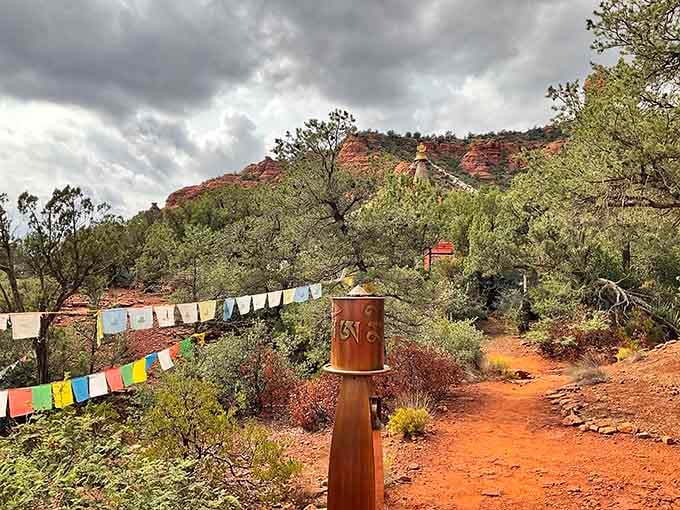 Prayer wheels and colorful flags transform a desert hillside into something that feels transported from Tibet.