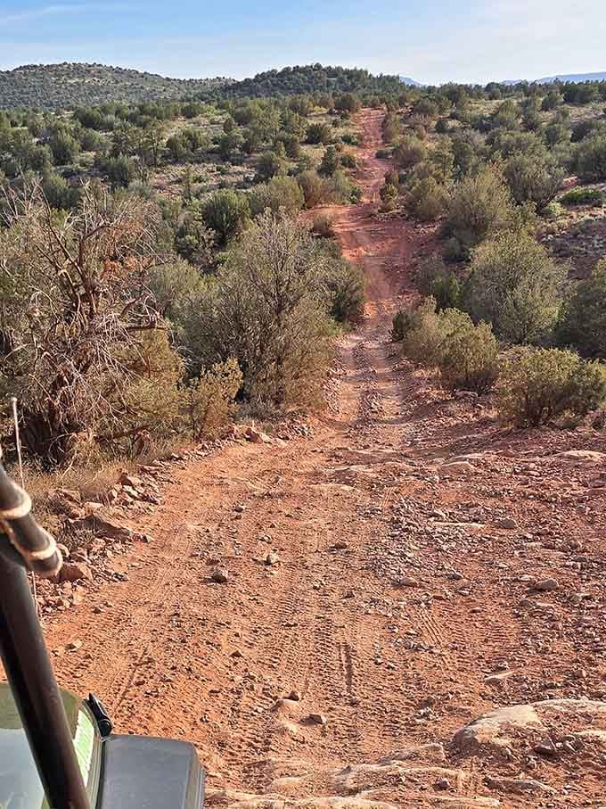 That red dirt trail ahead isn't asking if you're ready. It's just going.