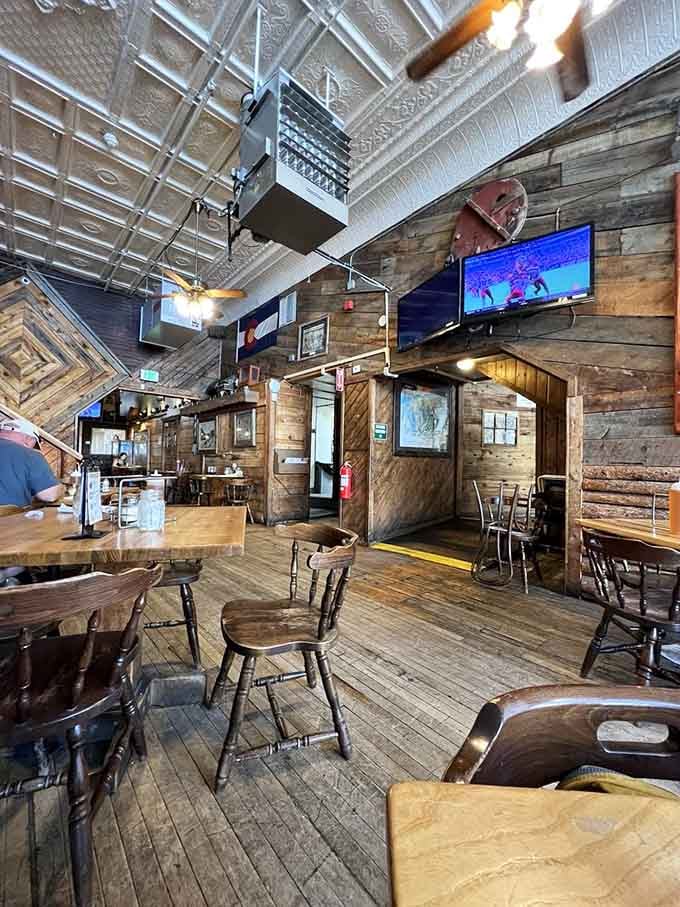 Rustic wood walls, creaky floors, and a Colorado flag overhead. This room has seen a thousand happy pizza nights.