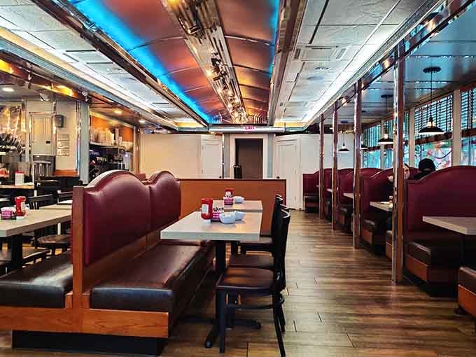Slide into one of these burgundy booths and suddenly every problem you walked in with feels negotiable.