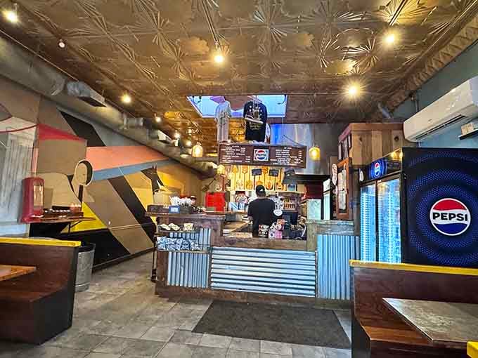 Industrial chic meets retro diner vibes under that gorgeous tin ceiling that reflects pure deliciousness.