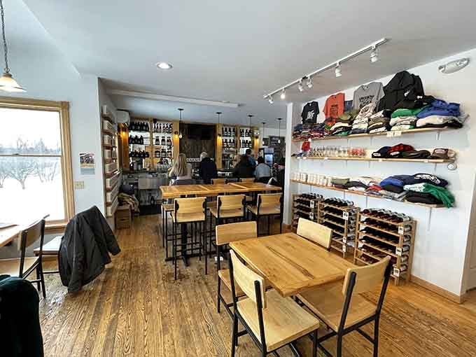 Warm wood tables, hardwood floors, and a merch wall that actually makes you want to open your wallet. Yes, really.