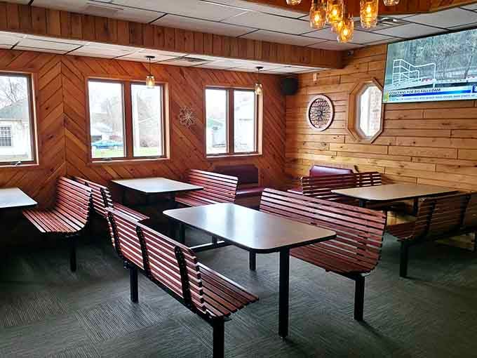 Warm wood paneling, slatted benches, and pendant lights, this dining room wraps around you like a favorite flannel shirt.