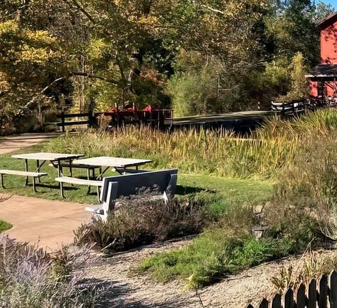 Picnic tables with a view of a historic mill and a quiet river. Lunch has never had better company.