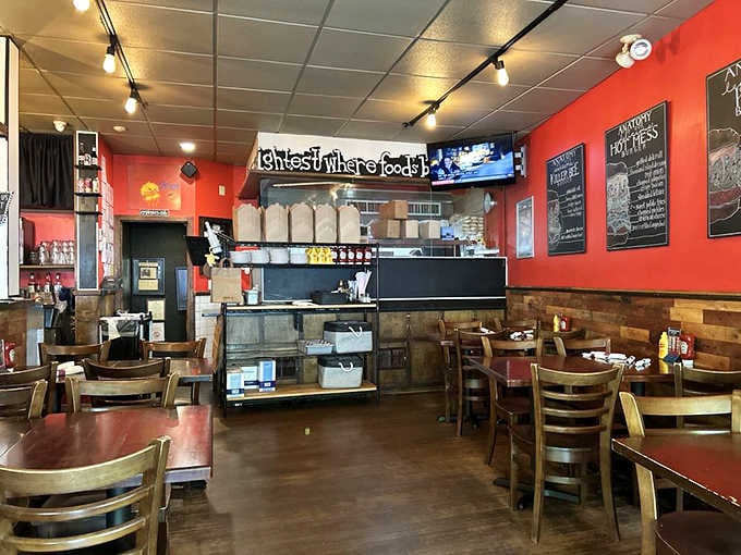 Bold red walls, warm lights, and chalkboard menus that practically dare you to order everything.