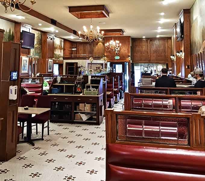 Dark wood, red leather booths, and chandelier light, this dining room has been welcoming guests longer than most of us have been alive.