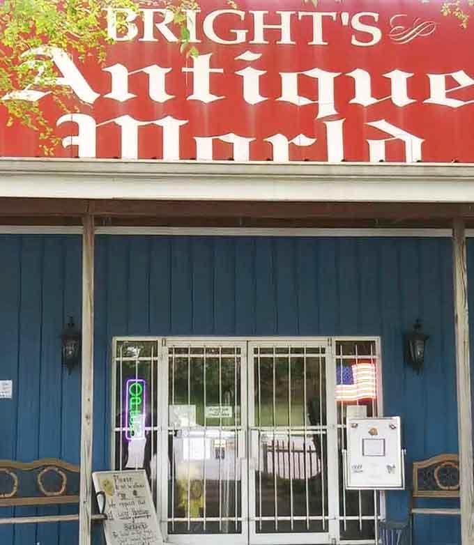 A glowing neon "Open" sign, an American flag, and antique chairs flanking the door. This entrance means business, the good kind.