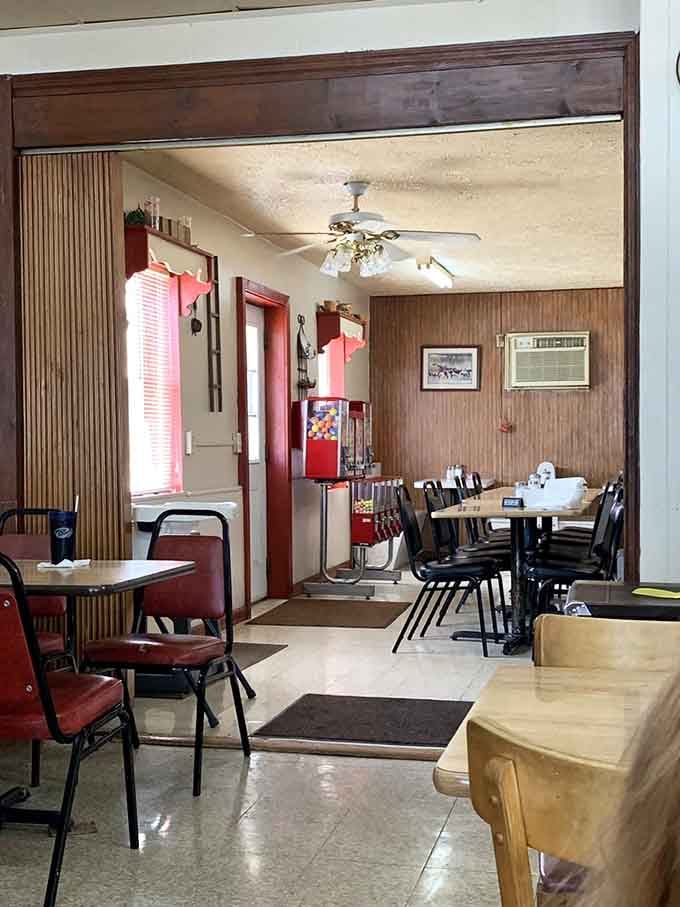 Wood paneling, red vinyl chairs, and a ceiling fan overhead &mdash; this dining room is pure, unfiltered comfort.