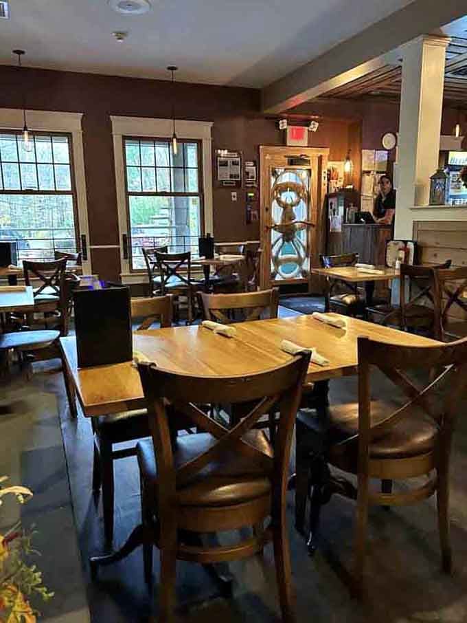 Warm wooden tables, cozy lighting, and that carved deer door — this dining room means serious, comfortable business.