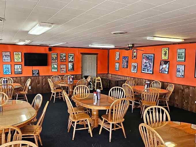 Bold orange walls, vintage wrestling posters, and Windsor chairs, this dining room has more personality than most people you know.