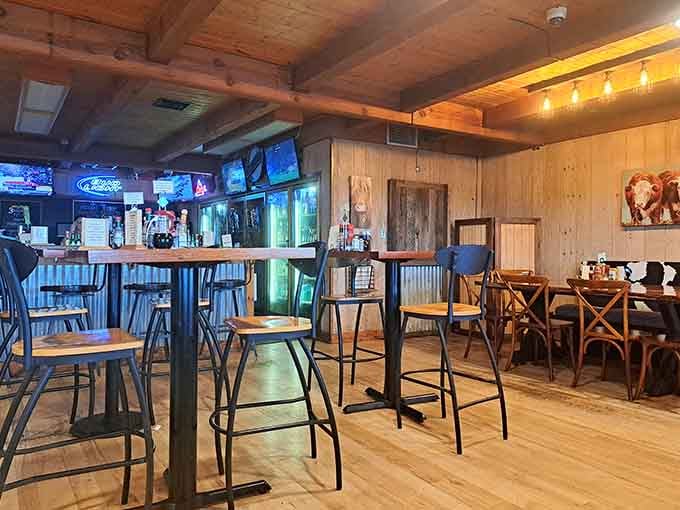 Warm wood beams, glowing neon, and cattle artwork on the walls. This room means serious comfort food business.