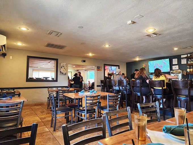 Warm wooden chairs, big screens, and a buzzing crowd — this dining room means serious business.